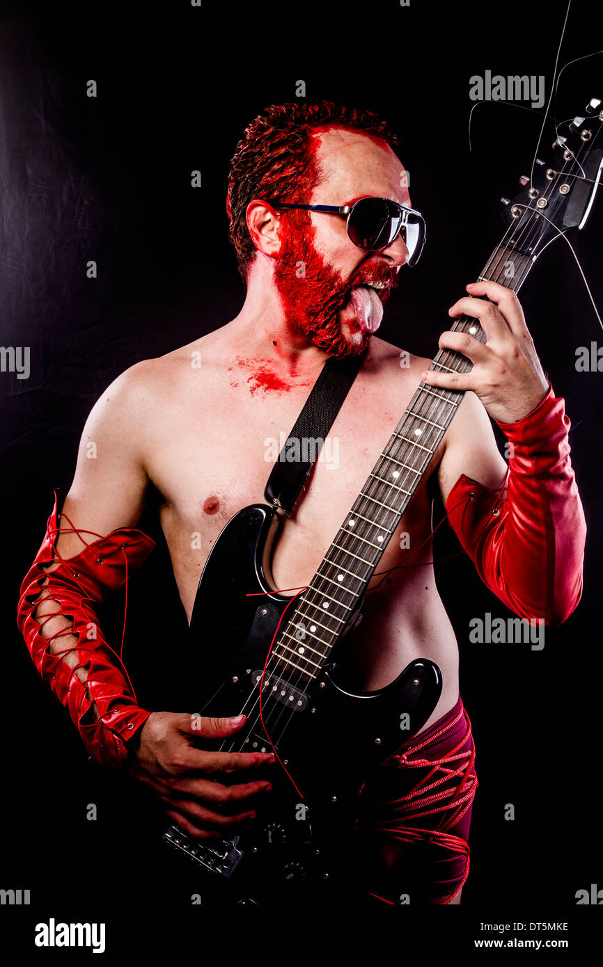 Electric, guitarist with electric guitar black, wearing face paint and ...