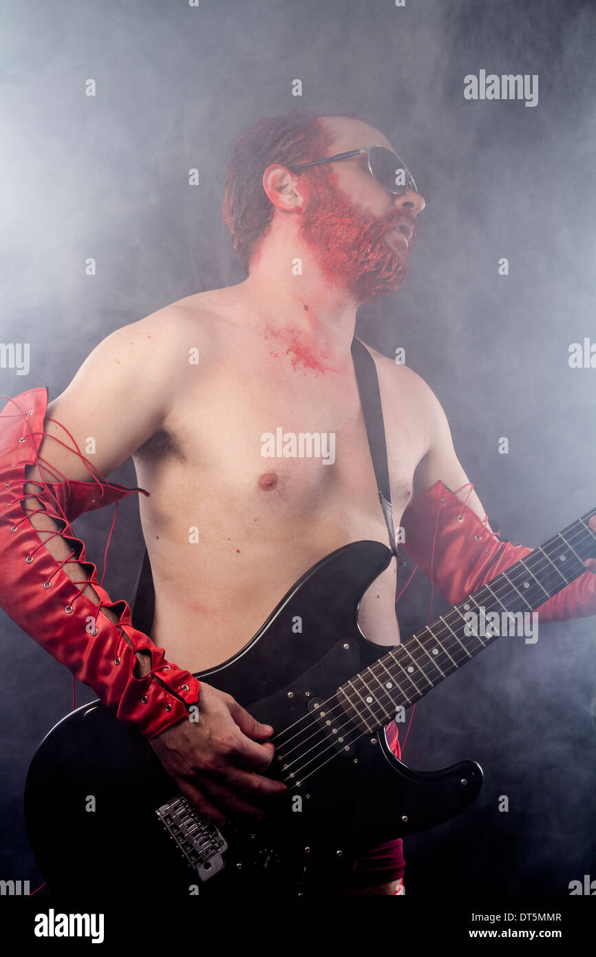 guitarist with electric guitar black, wearing face paint and red ...