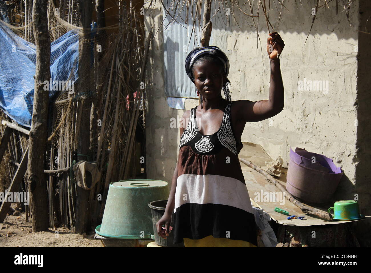 Dakar, Senegal. 4th Feb, 2014. A villager stands in front of a house in ...