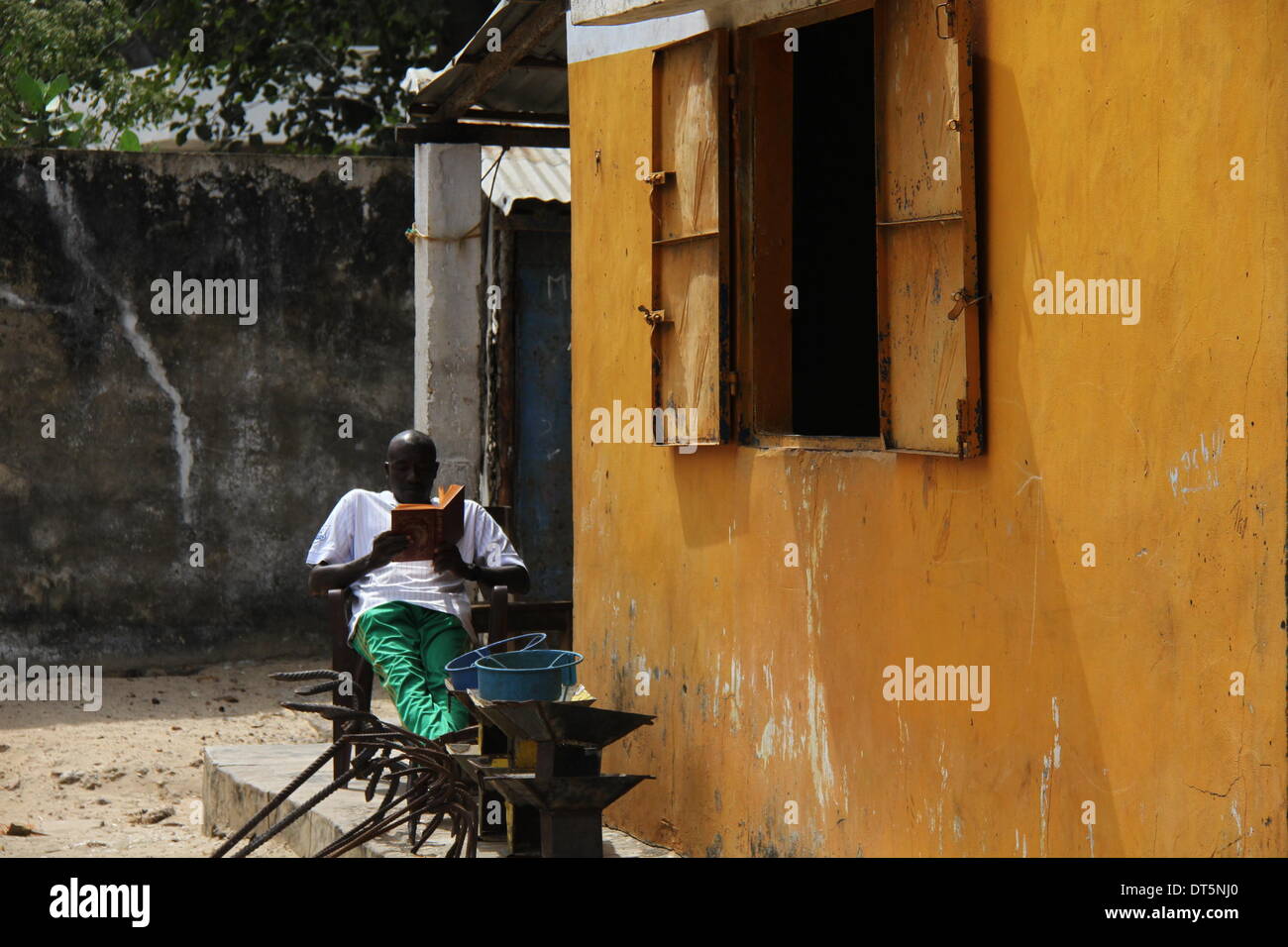 Dakar, Senegal. 4th Feb, 2014. A villager reads a book in a village of ...