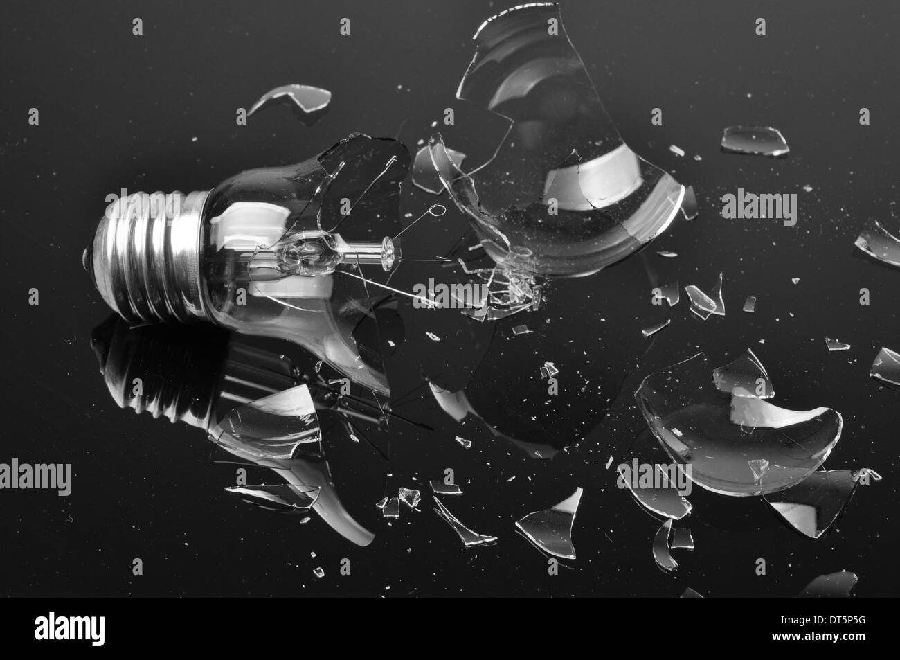 Broken bulb on black background Stock Photo - Alamy