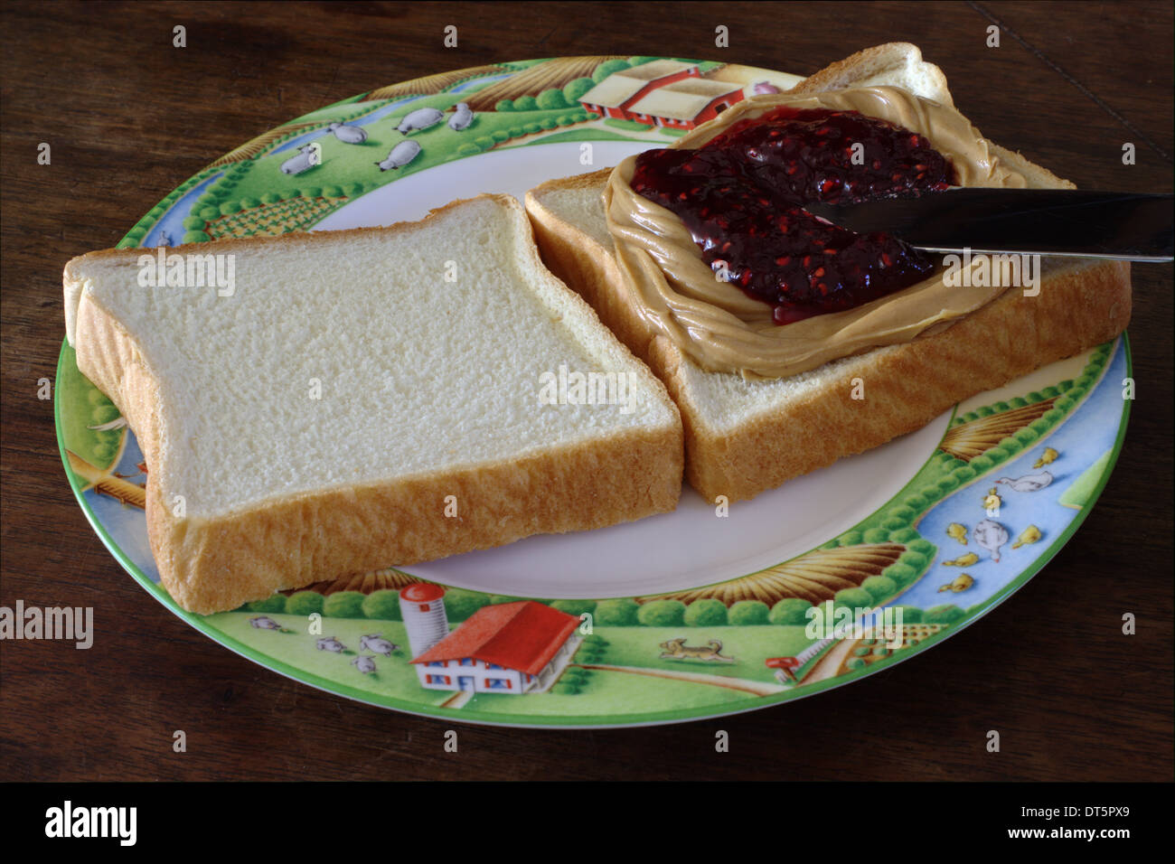 Jelly being spread on peanut butter Stock Photo - Alamy
