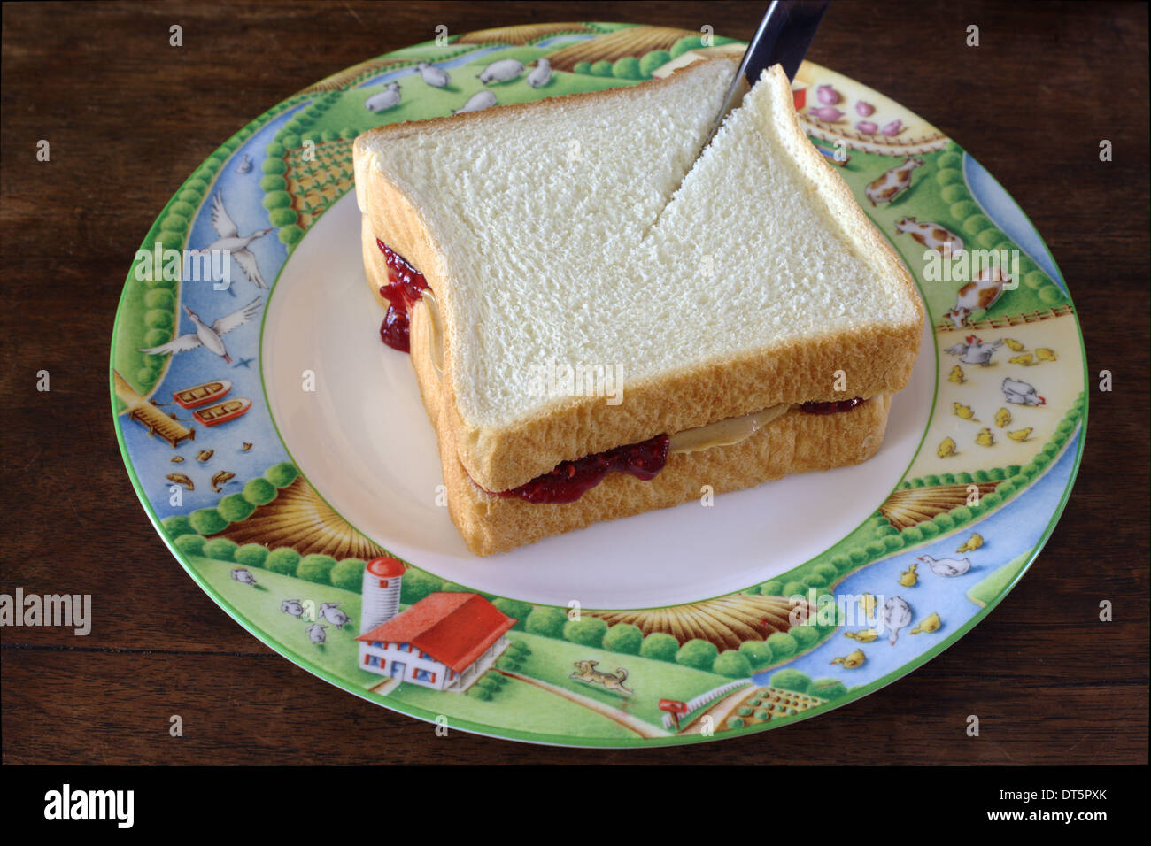 Peanut butter and jelly sandwich being cut diagonally Stock Photo - Alamy