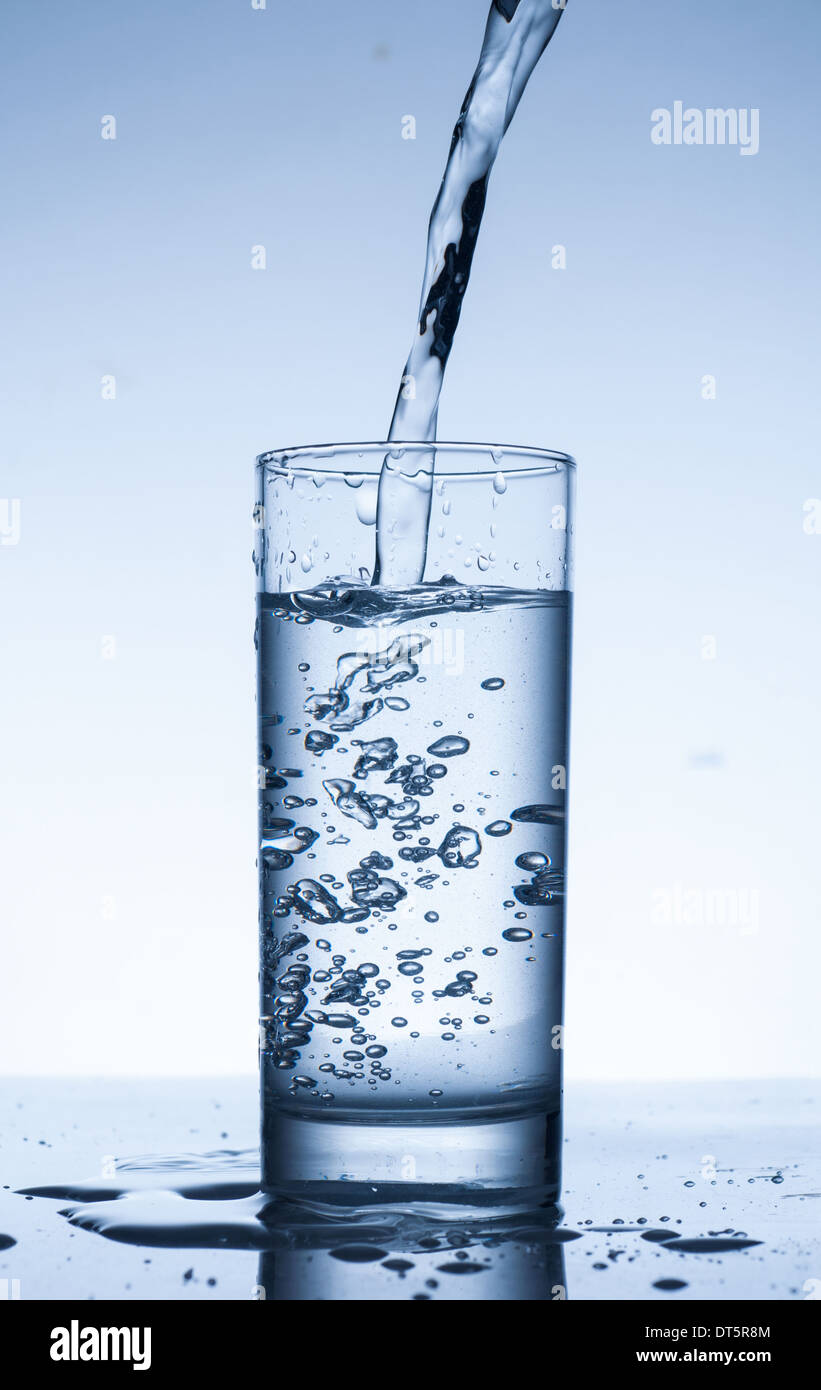 Pouring water into glass Stock Photo - Alamy