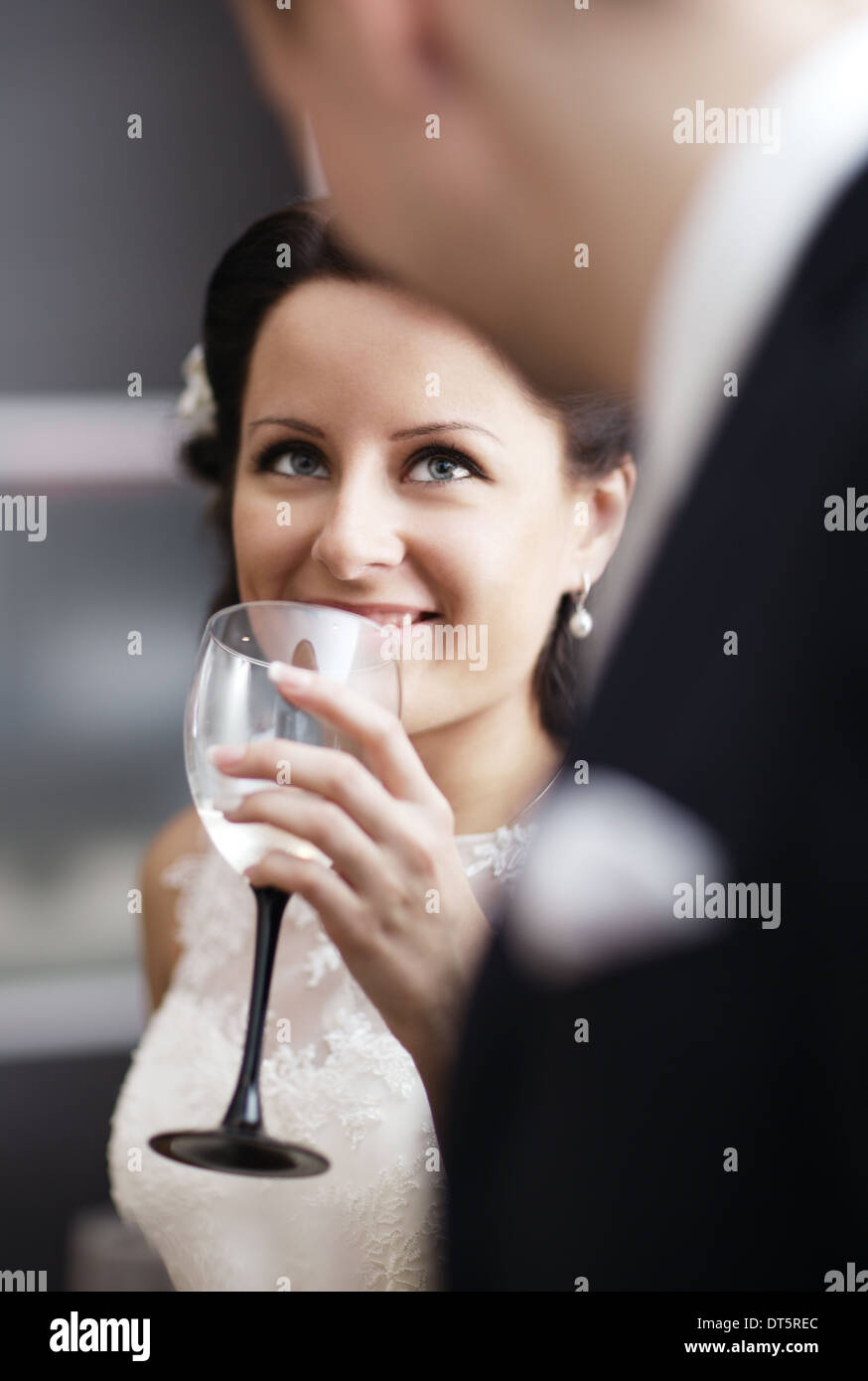 Elegant woman drinking wine at a function Stock Photo - Alamy