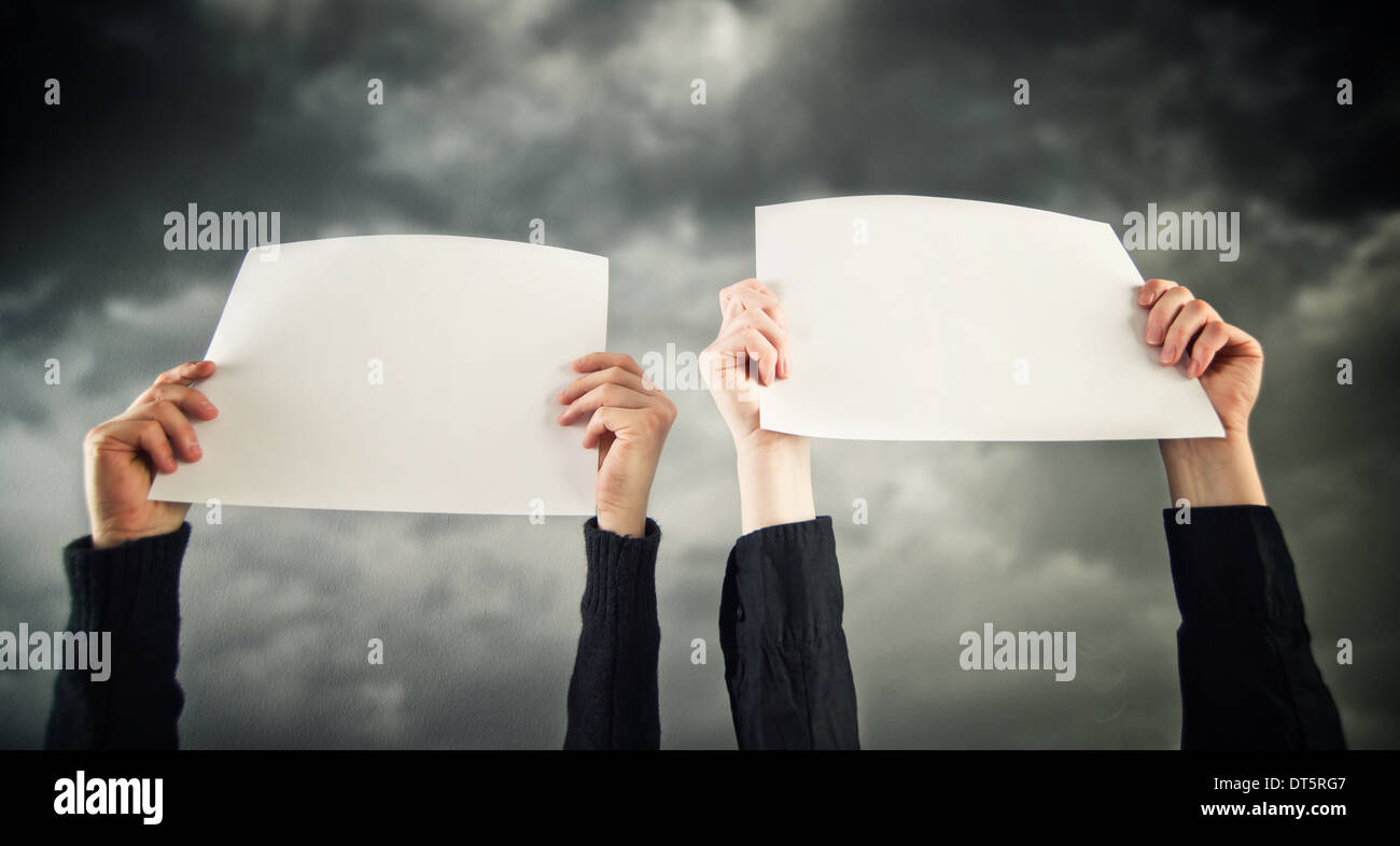 Two women holding blank paper above their heads Stock Photo - Alamy