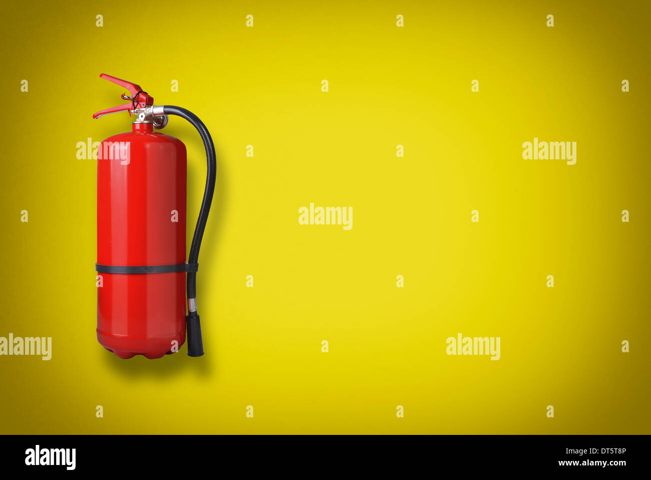 fire extinguisher on yellow wall Stock Photo - Alamy