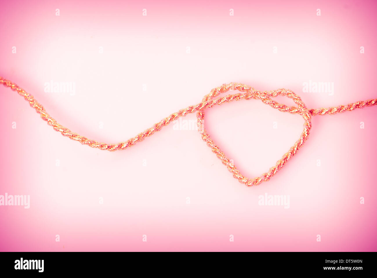 Heart shape from gold rope on pink background. Love postcard Stock ...