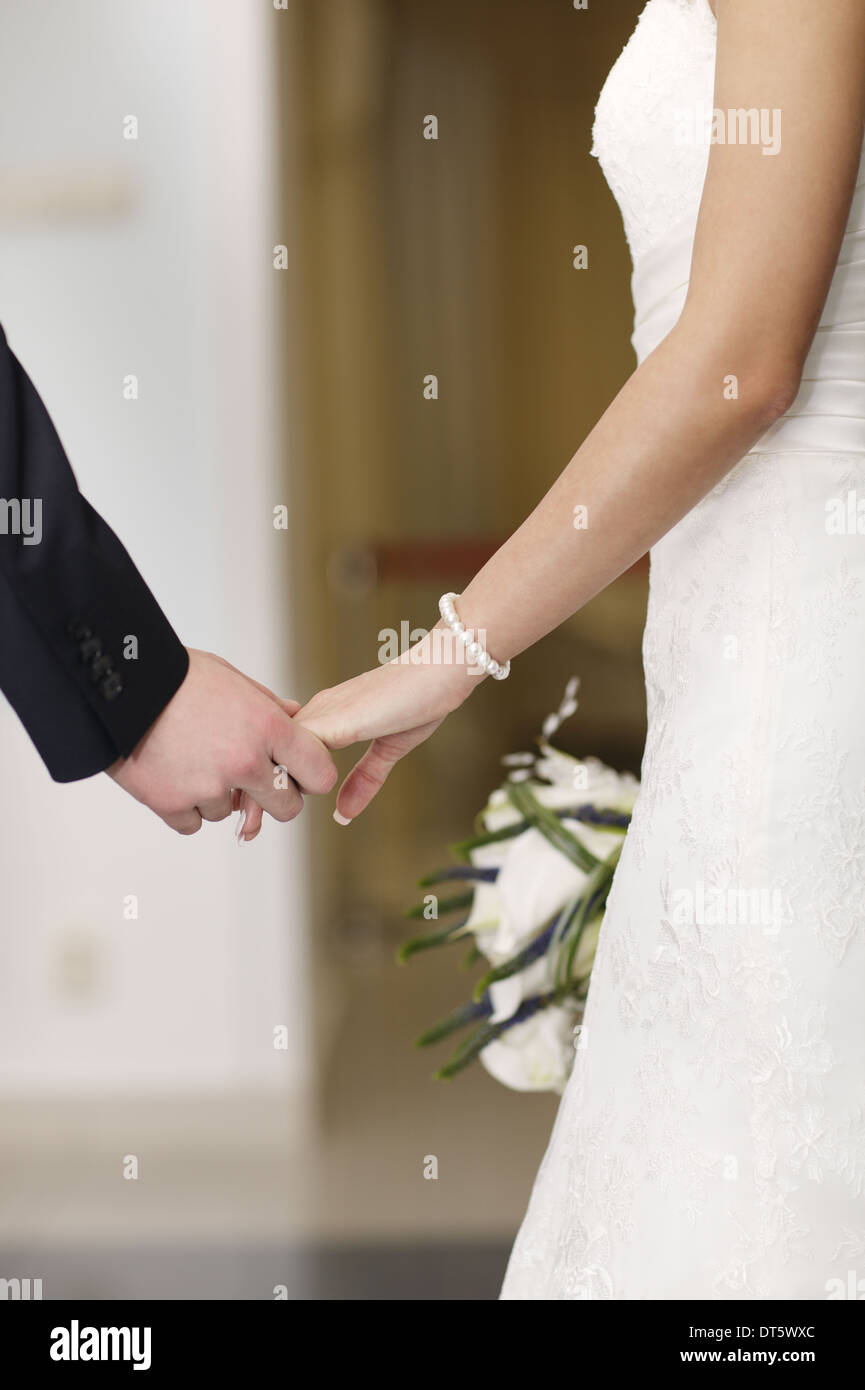 Bride and groom holding hands Stock Photo - Alamy