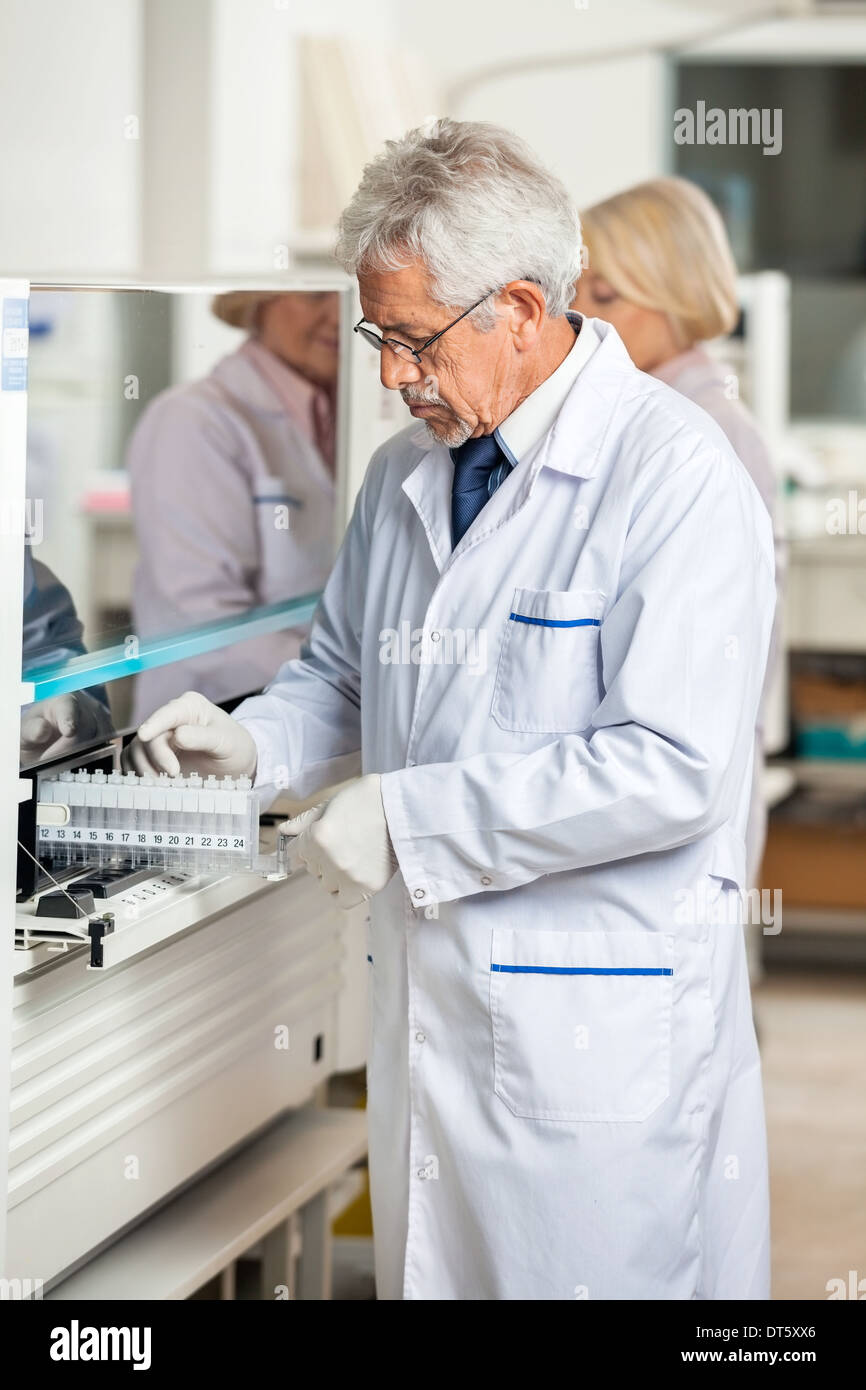 Technician Loading Analyzer With Samples Stock Photo - Alamy