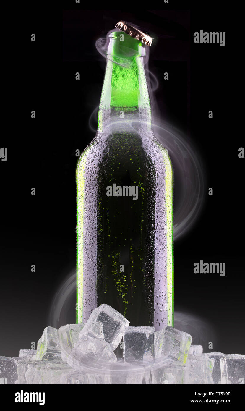 Cold beer bottle with chill smoke on black background Stock Photo - Alamy