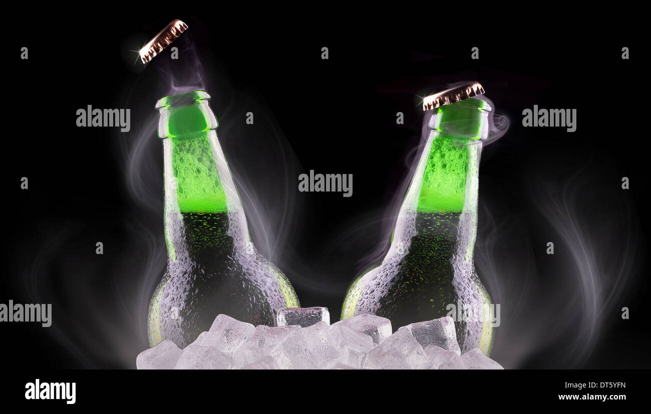 Cold beer bottle with chill smoke on black background Stock Photo - Alamy