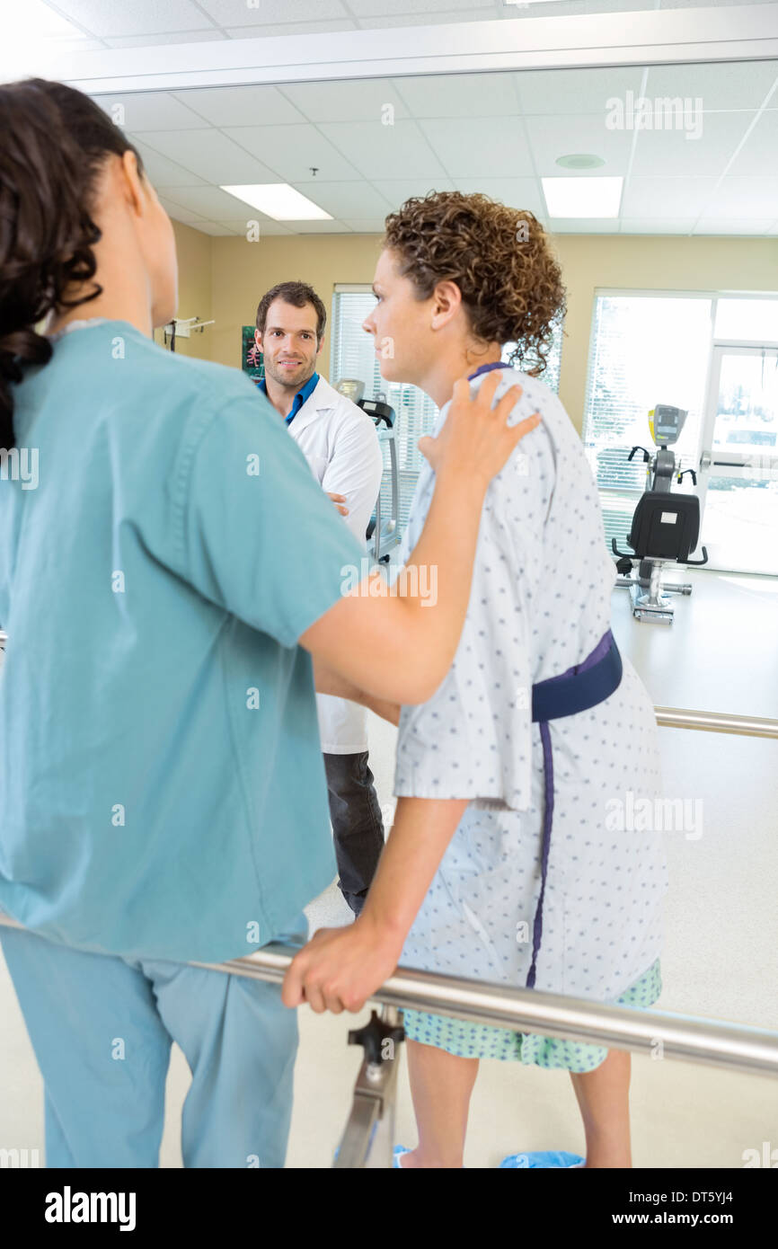 Physical Therapist Assisting Female Patient In Walking Stock Photo - Alamy