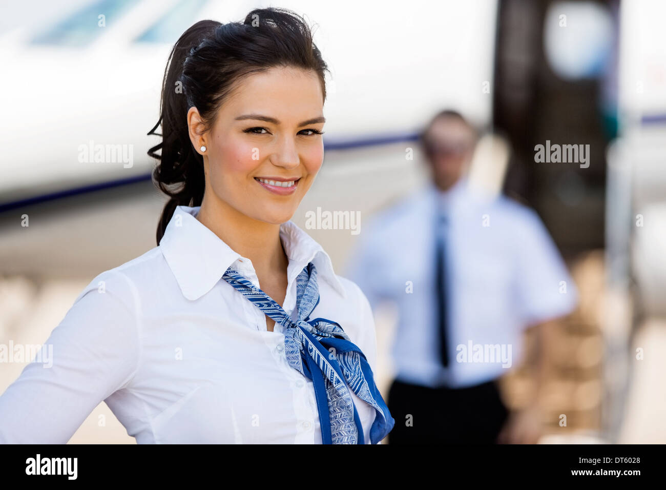 Stewardesses Smiling With Pilot And Private Jet In Background Stock ...