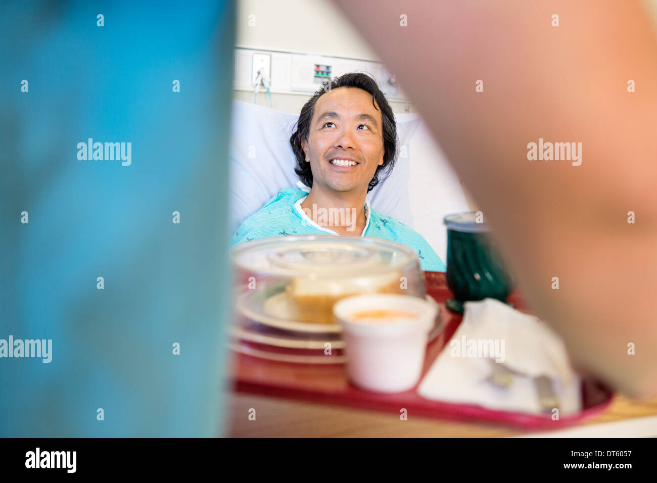 Happy Patient Looking At Nurse Serving Breakfast Stock Photo - Alamy