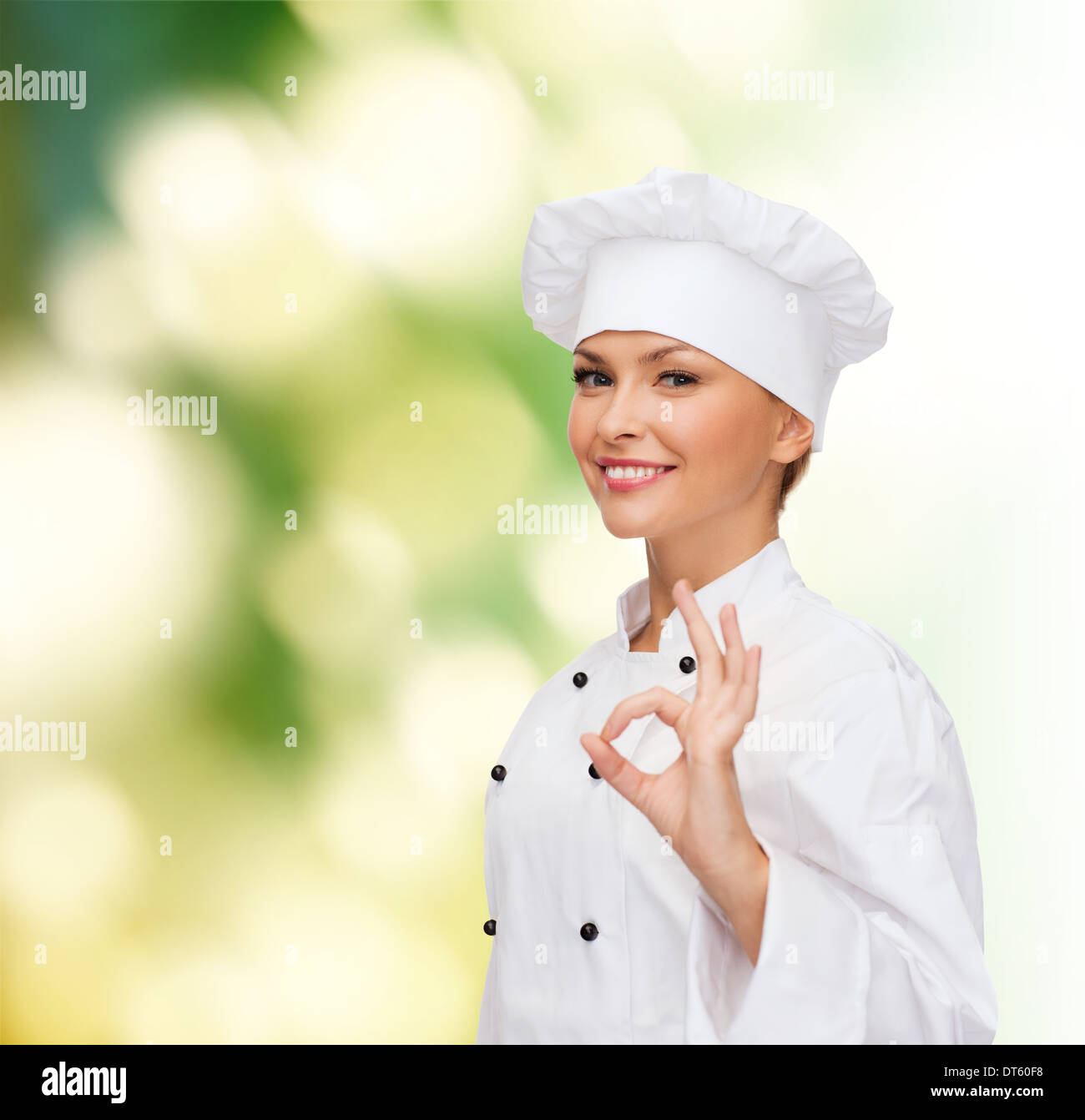 smiling female chef showing ok hand sign Stock Photo - Alamy