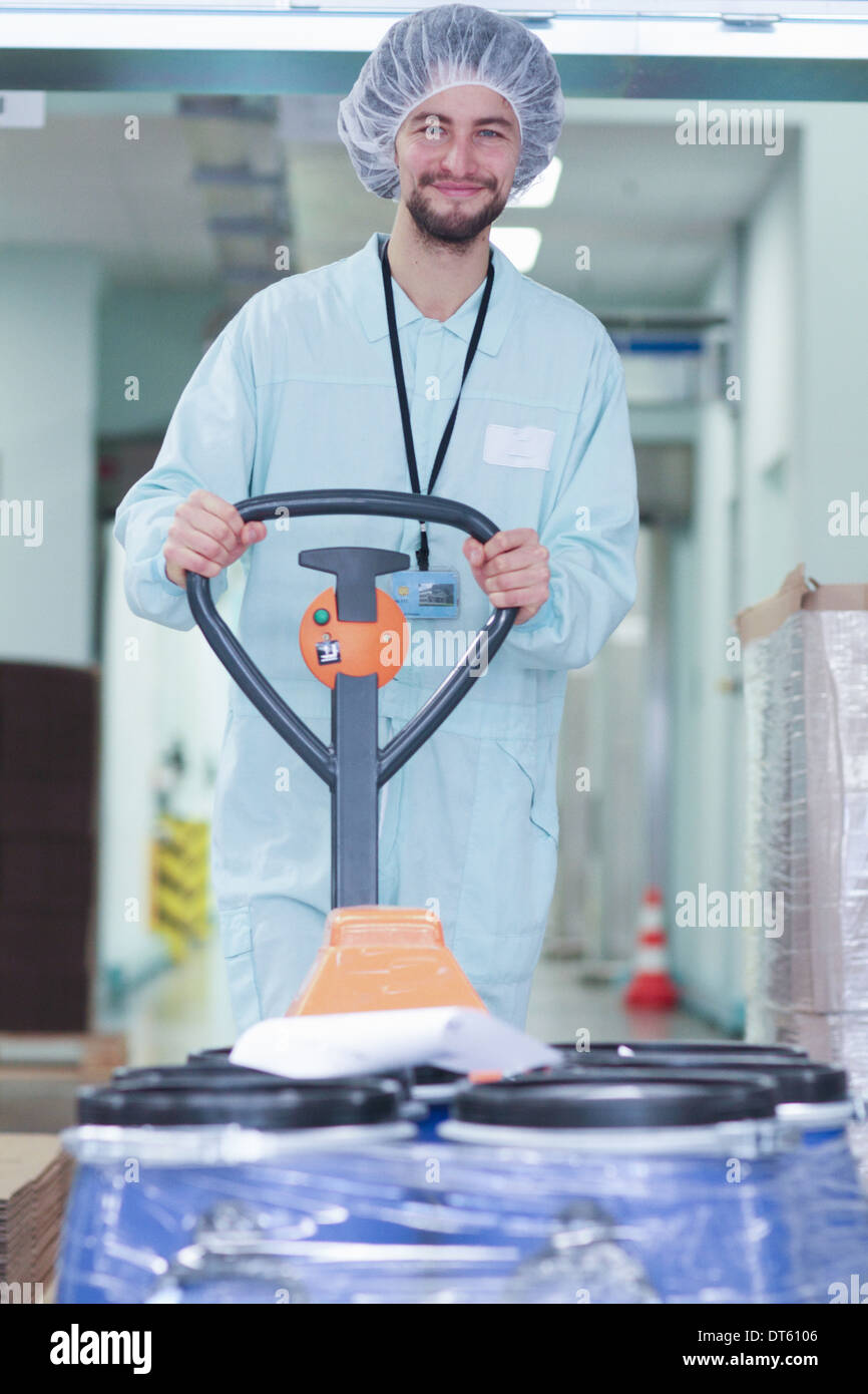 Laboratory technician moving containers Stock Photo - Alamy