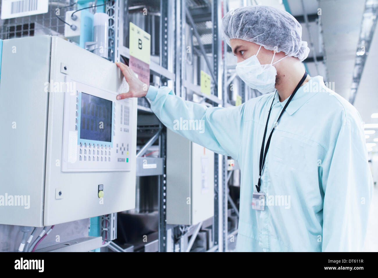Laboratory technician checking and adjusting equipment reading Stock ...