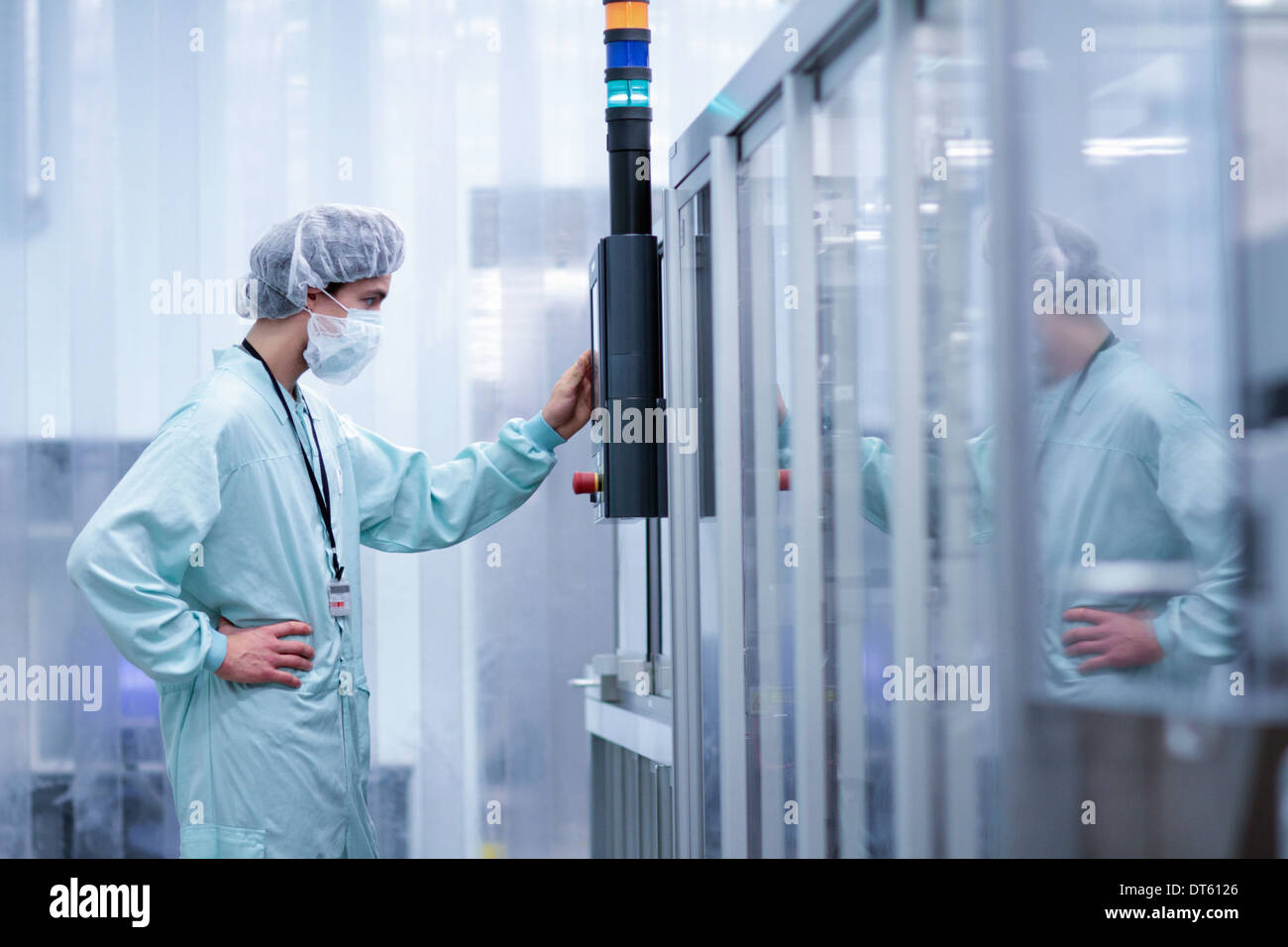 Laboratory technician checking and adjusting equipment reading Stock ...