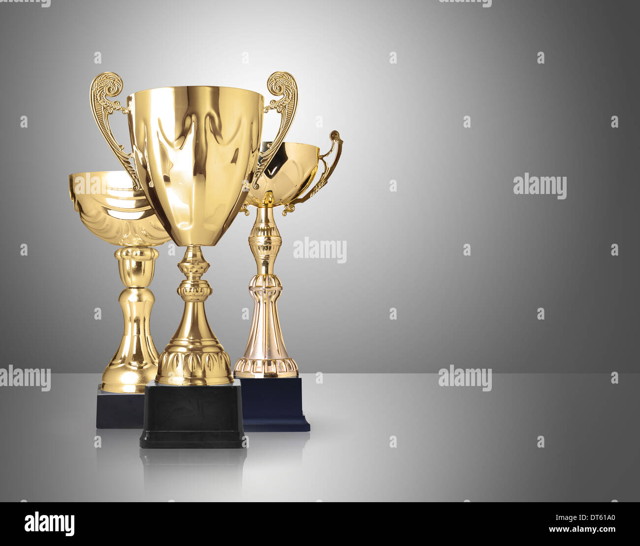 three different kind of golden trophies on gray background Stock Photo ...