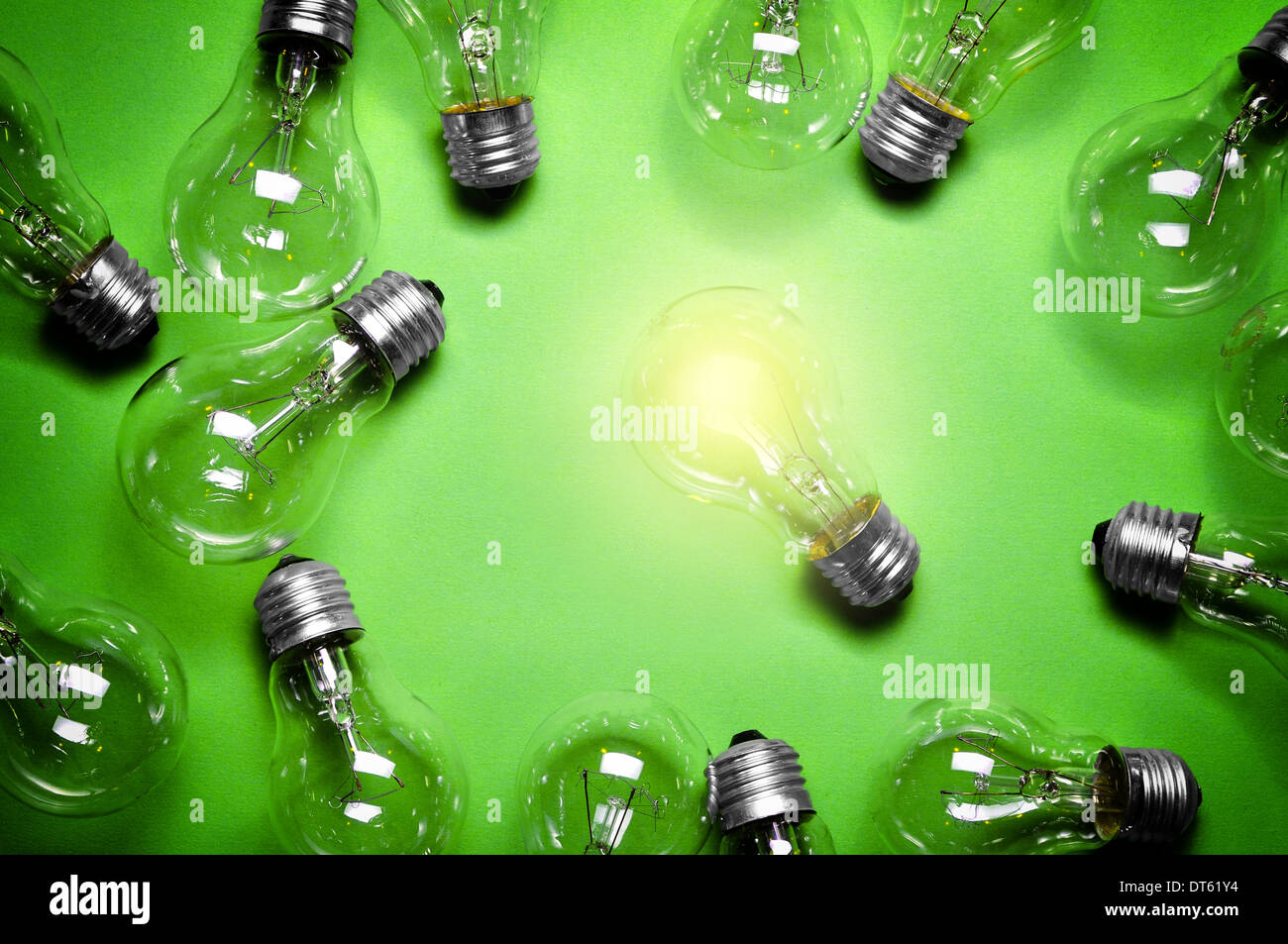 Idea concept with light bulbs on green background Stock Photo - Alamy