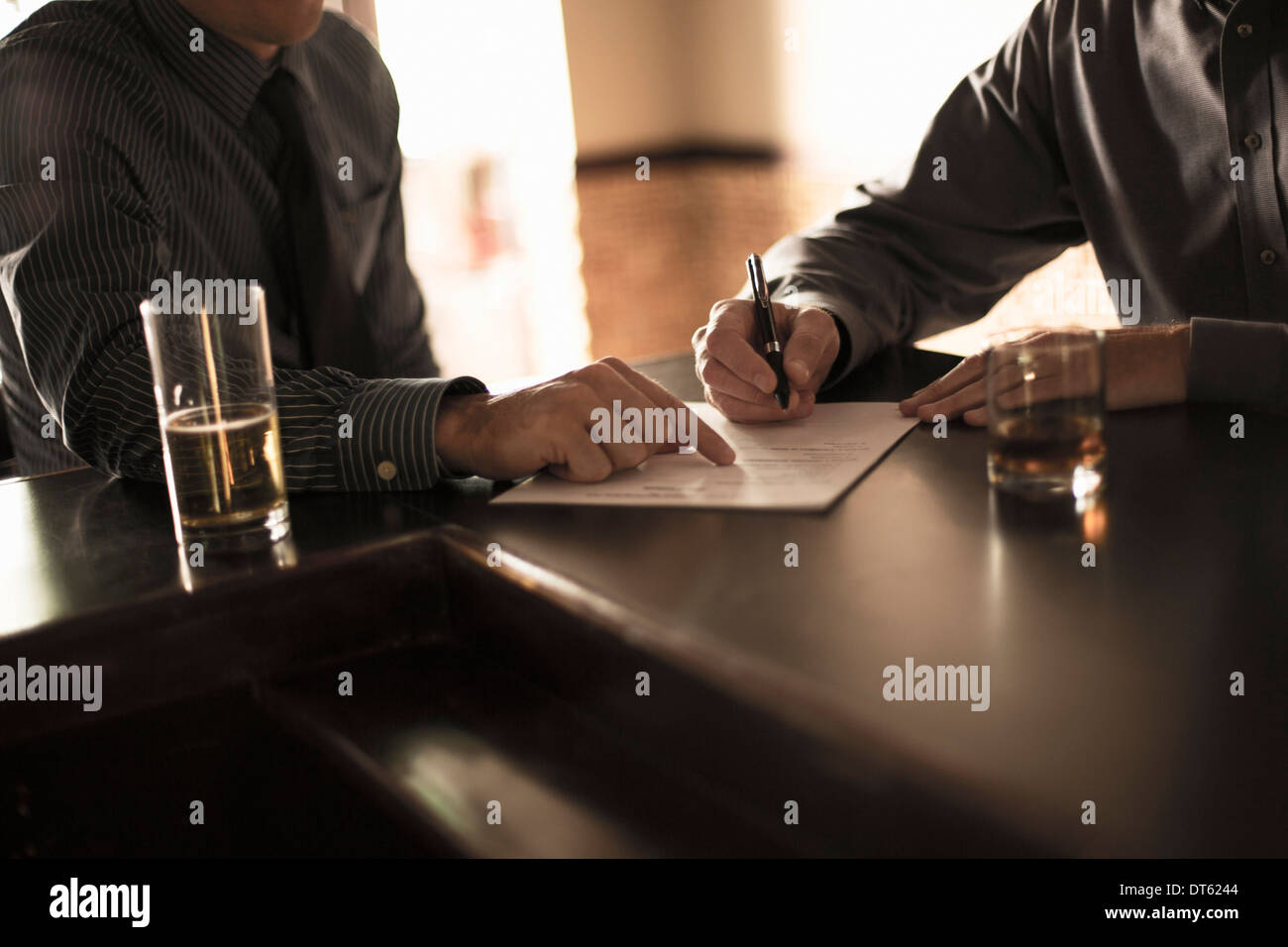 Business people signing contract two hi-res stock photography and ...