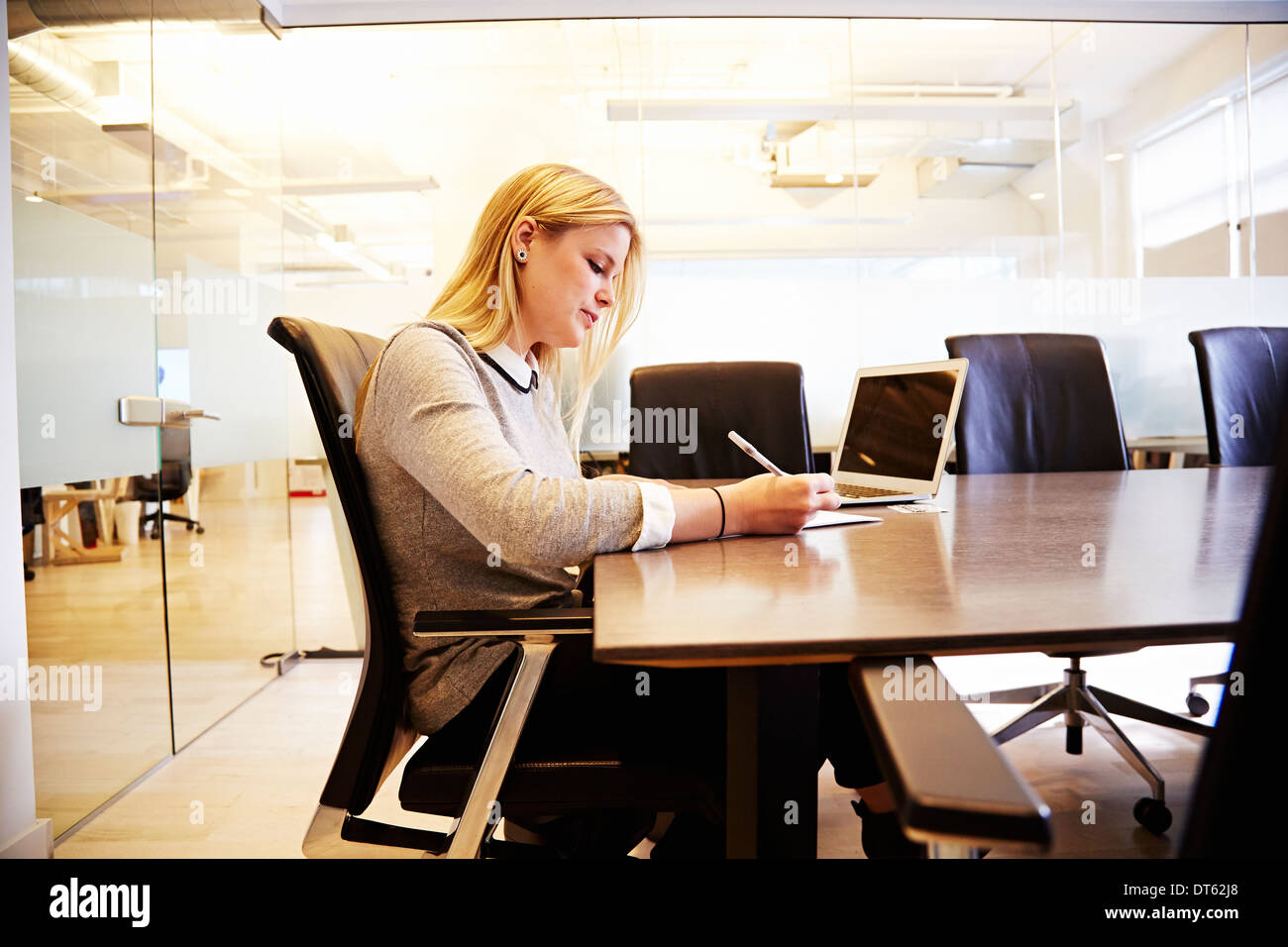 Young woman working at table Stock Photo - Alamy