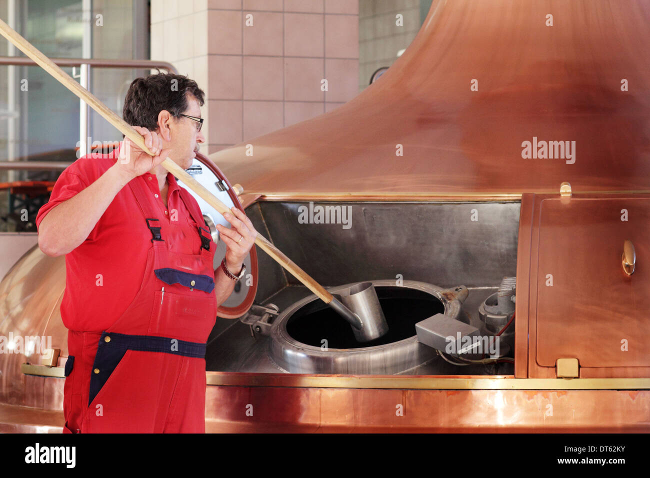 Man stirring vat in brewery Stock Photo - Alamy