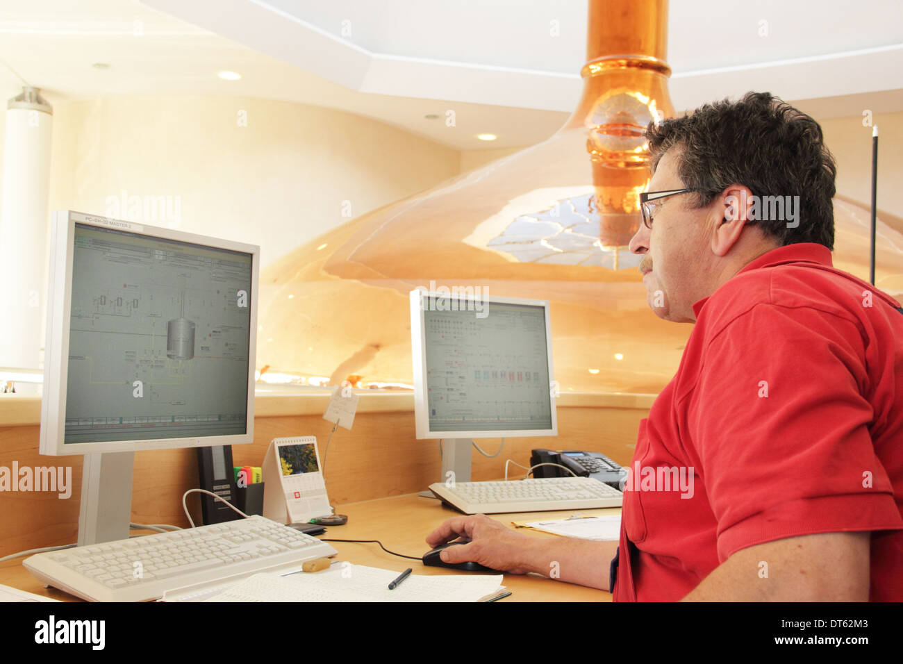 Man using computer at desk Stock Photo - Alamy