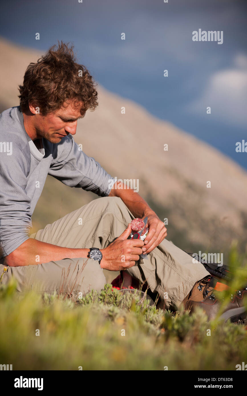 Hiker having snack Stock Photo - Alamy