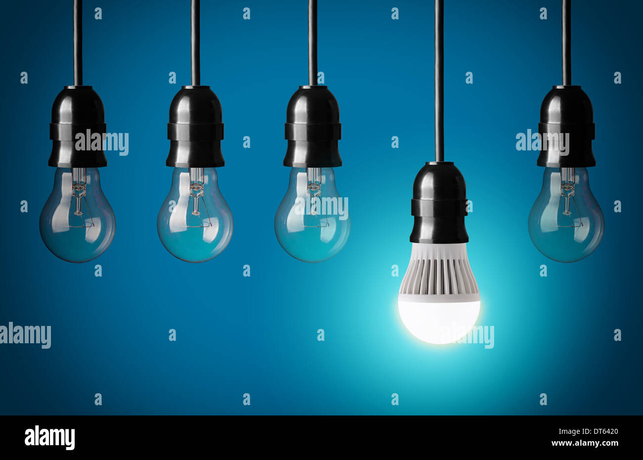 Glowing LED bulb and simple light bulbs Stock Photo - Alamy