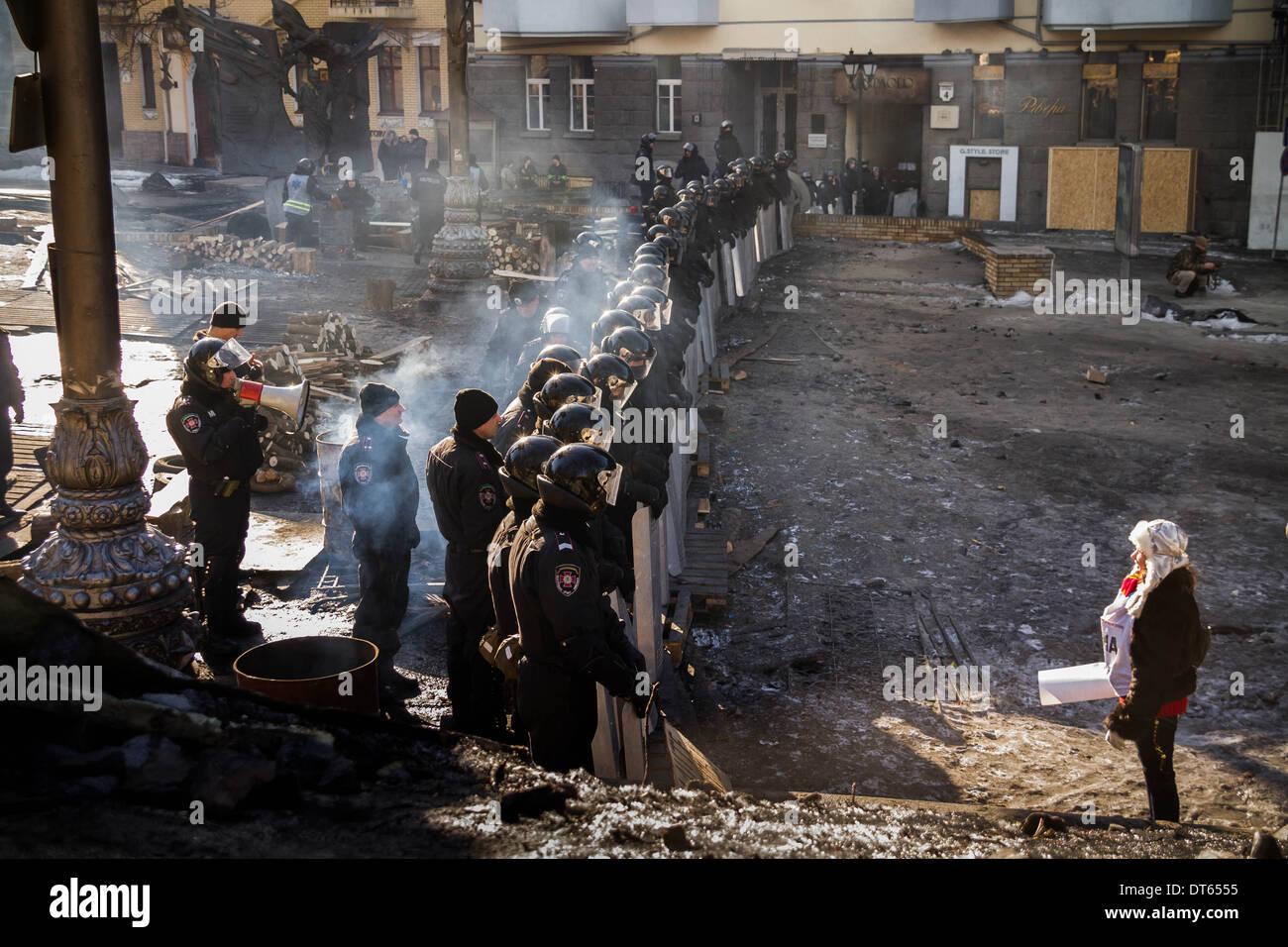 A Euromaidan protester (R) confronts pro-government riot police line ...