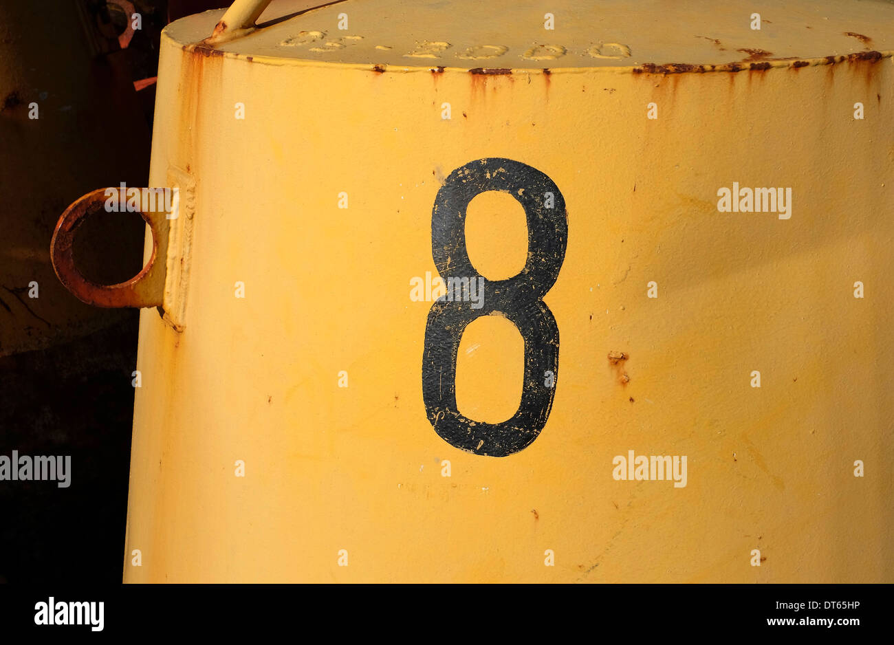 number 8 painted on metal yellow buoy Stock Photo - Alamy