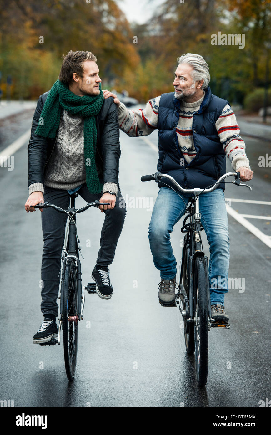 Friends cycling on street Stock Photo - Alamy
