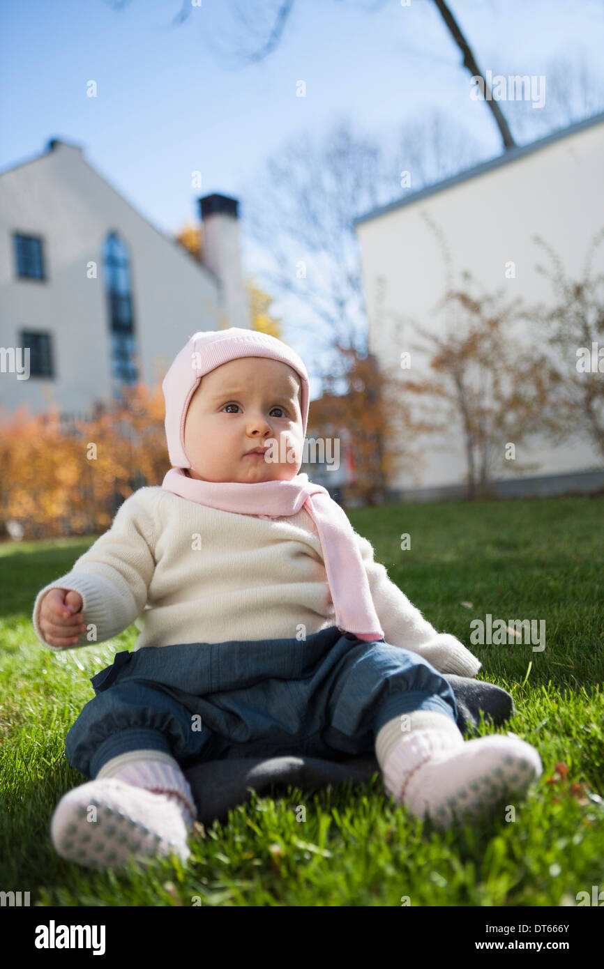 Baby sitting on grass Stock Photo - Alamy