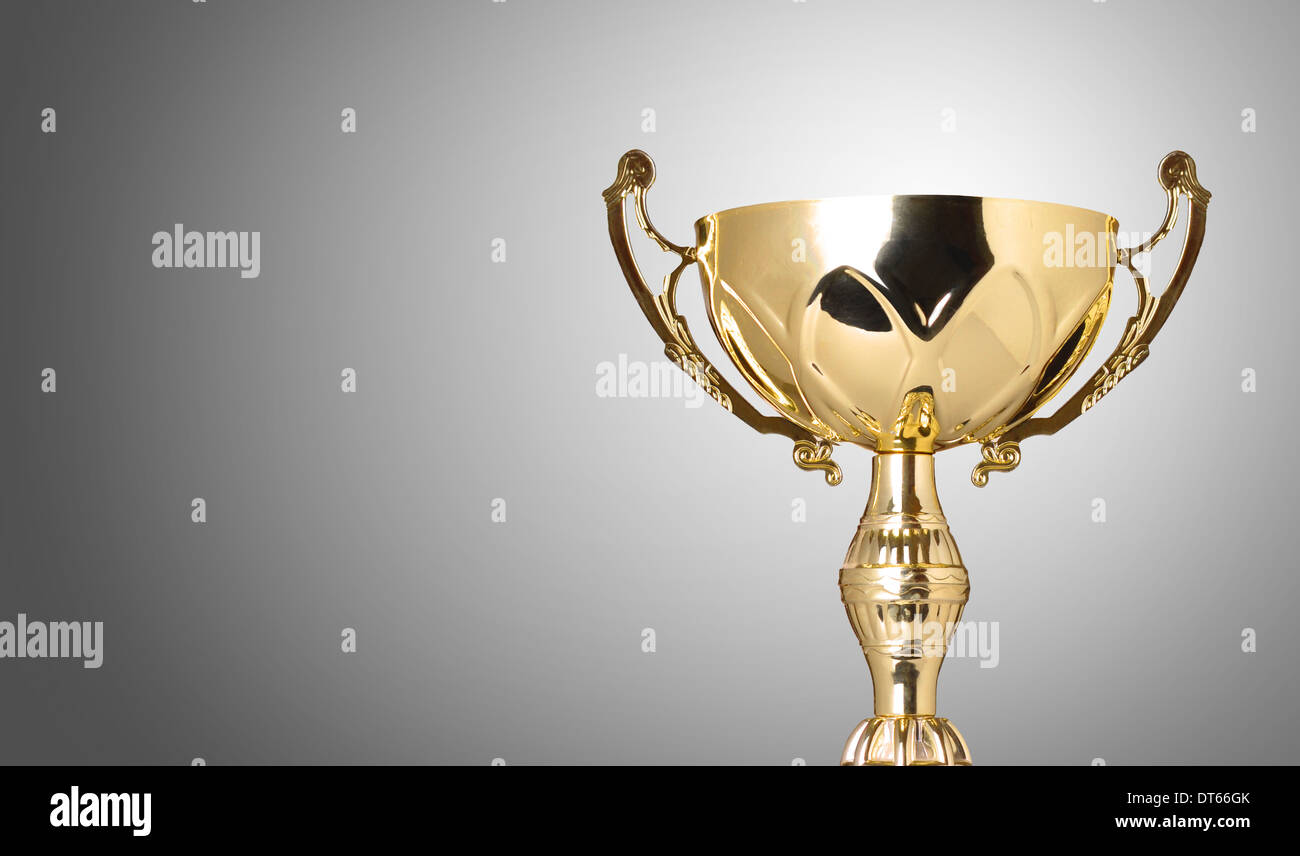 close up champion golden trophy on grey background Stock Photo - Alamy