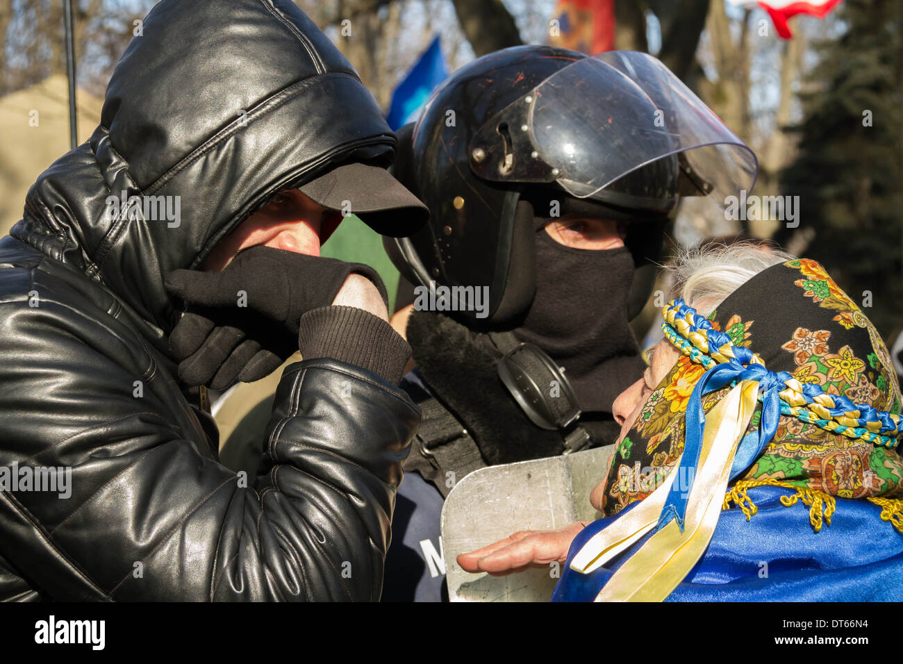 A women Euromaidan protester confronts rows of government riot police ...