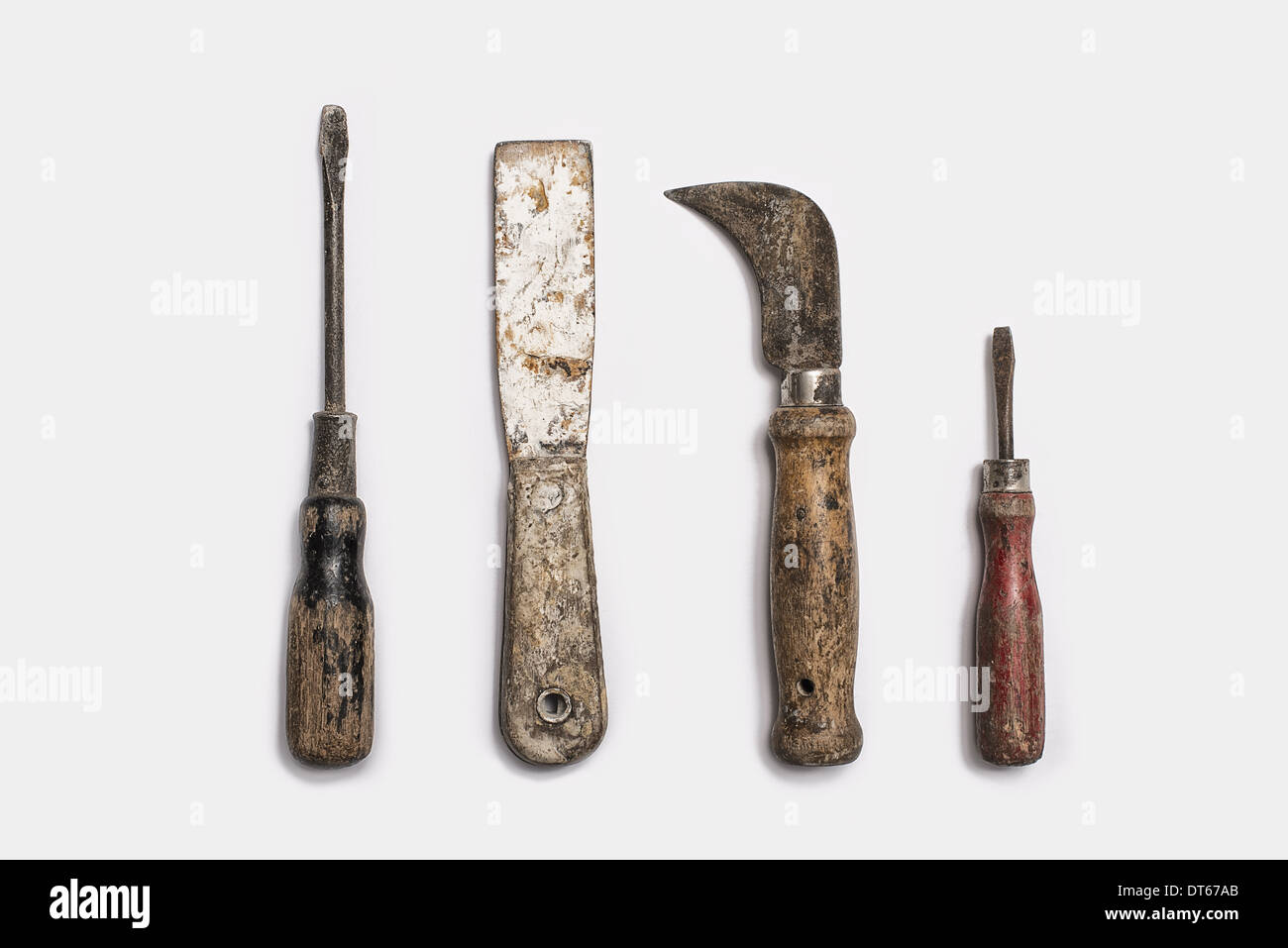 Used tools arranged in a row. Well used, worn handles, shaped wooden ...