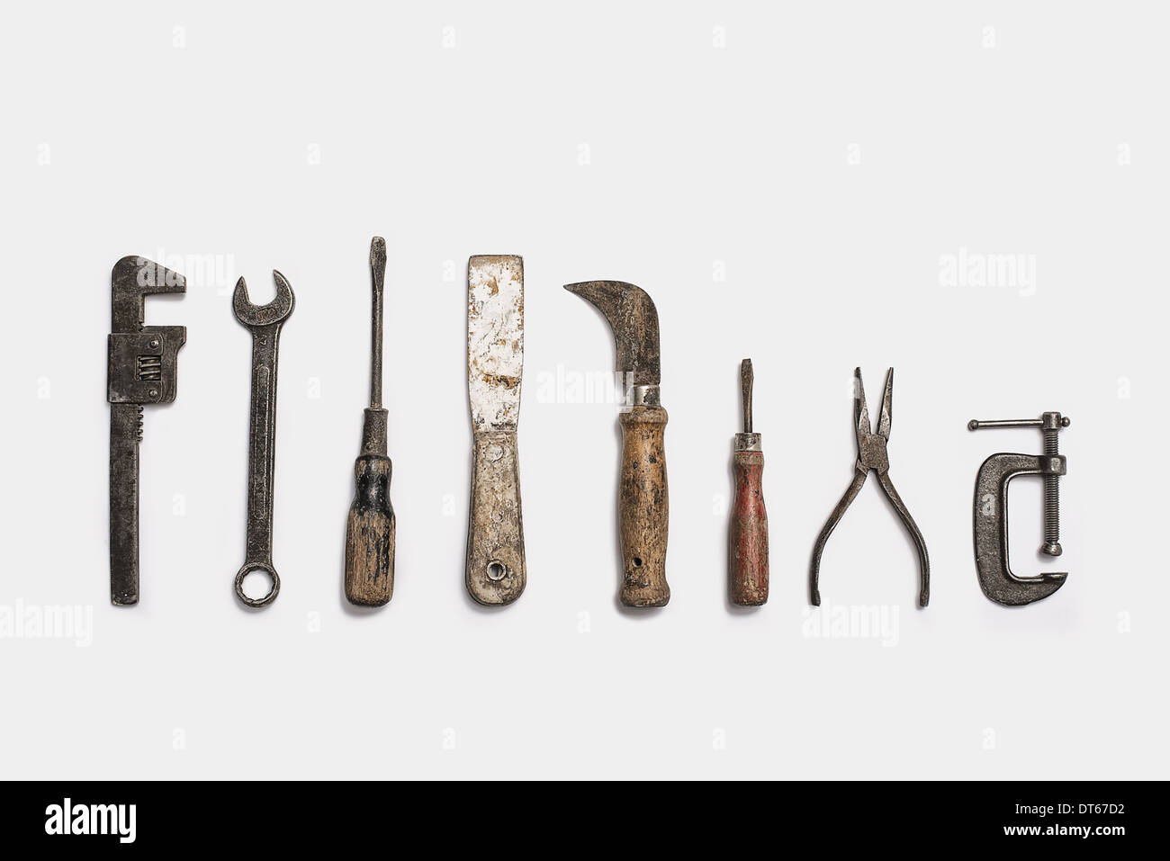 Used tools arranged in a row. Well used, worn handles, shaped wooden ...