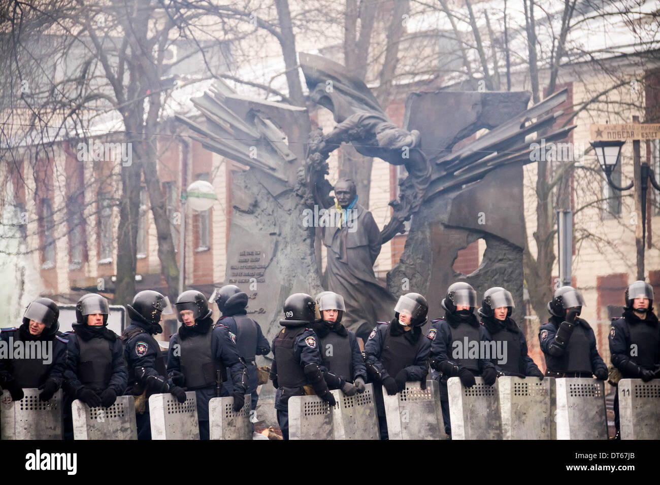 Rows of government riot police firmly guard the road leading up to the ...