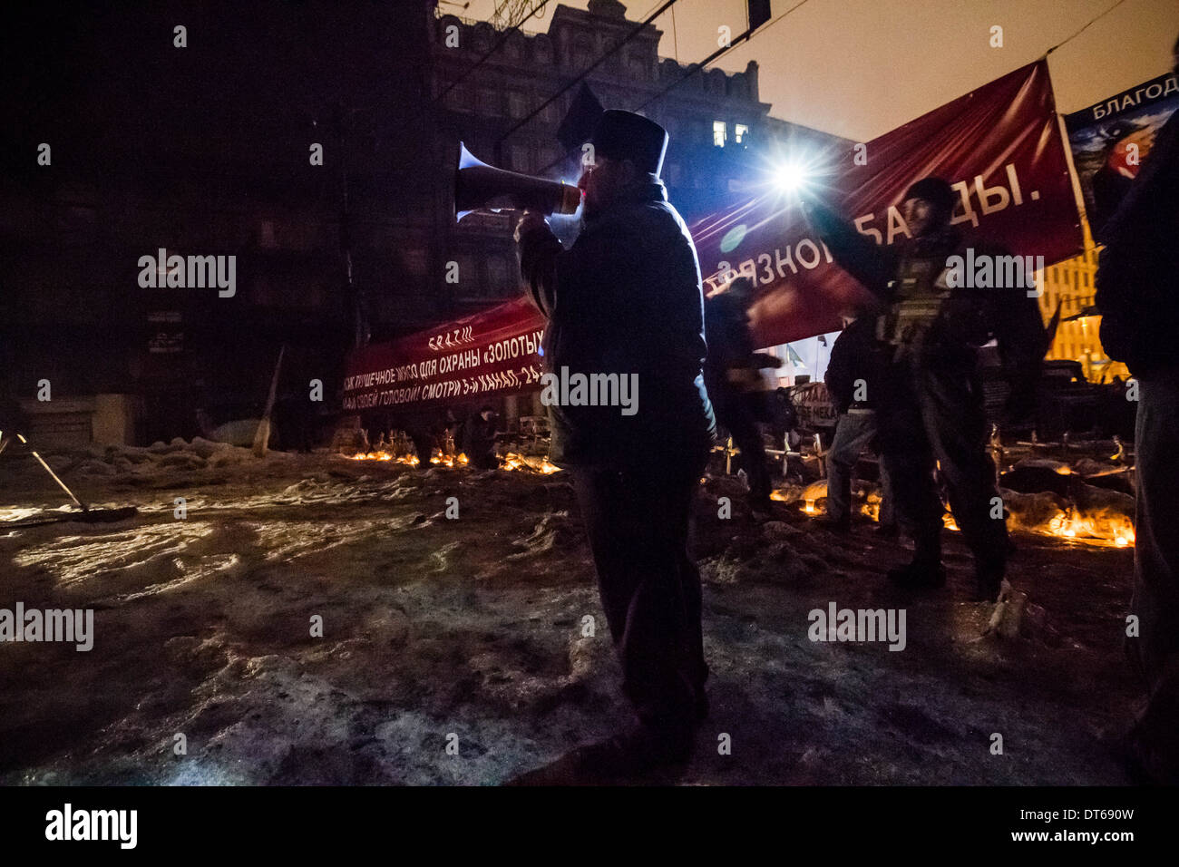 A priest directs prayers towards riot police. A night vigil was held by ...