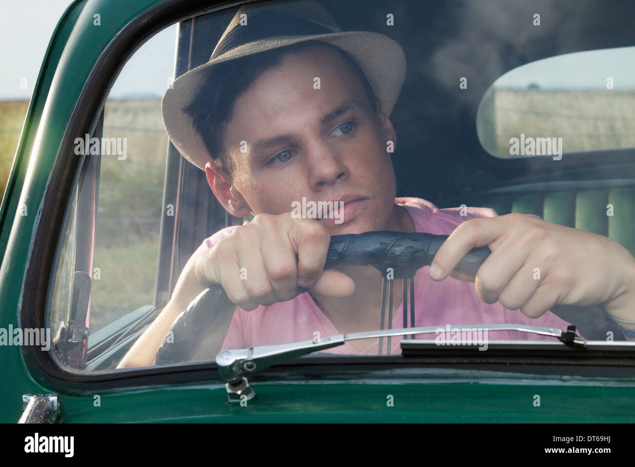 Young man looking through windscreen of vintage morris minor Stock ...