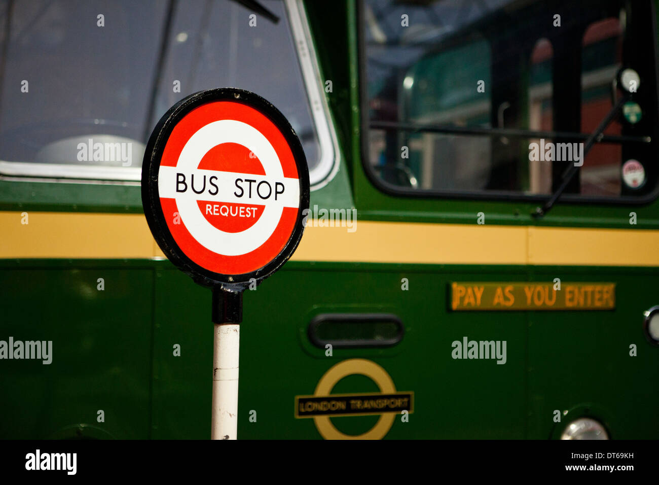 Old fashioned bus stop sign in front of bus at Brooklands Museum in ...