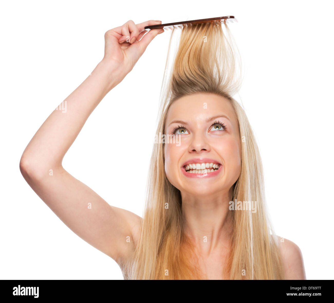 Smiling young woman combing hair Stock Photo - Alamy