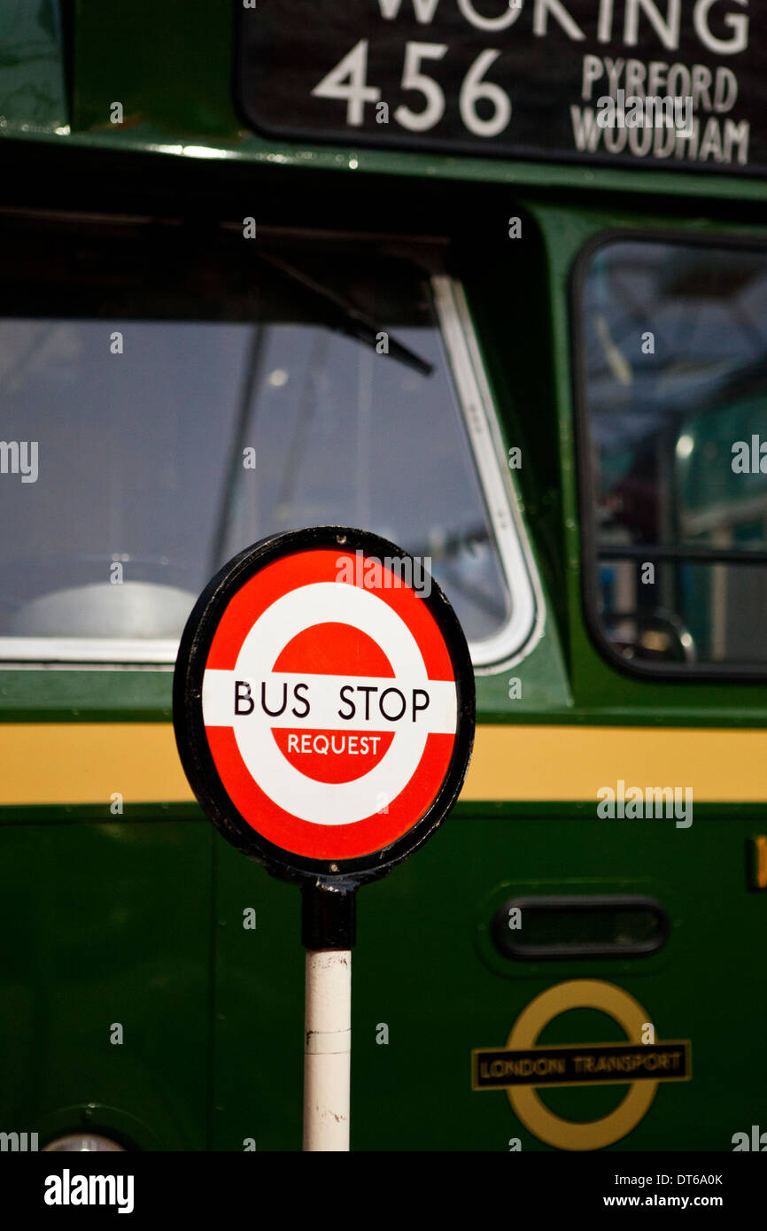 Old fashioned bus stop sign in front of bus at Brooklands Museum in ...