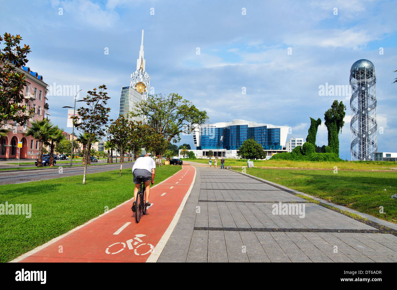 Cyclist run on bicycle track to Kempinski Hotel and Georgian Alphabet ...