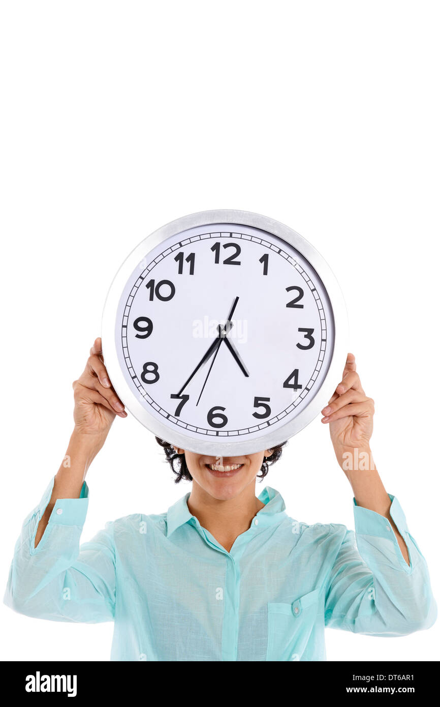 hispanic business woman looking at camera and hiding behind big clock ...