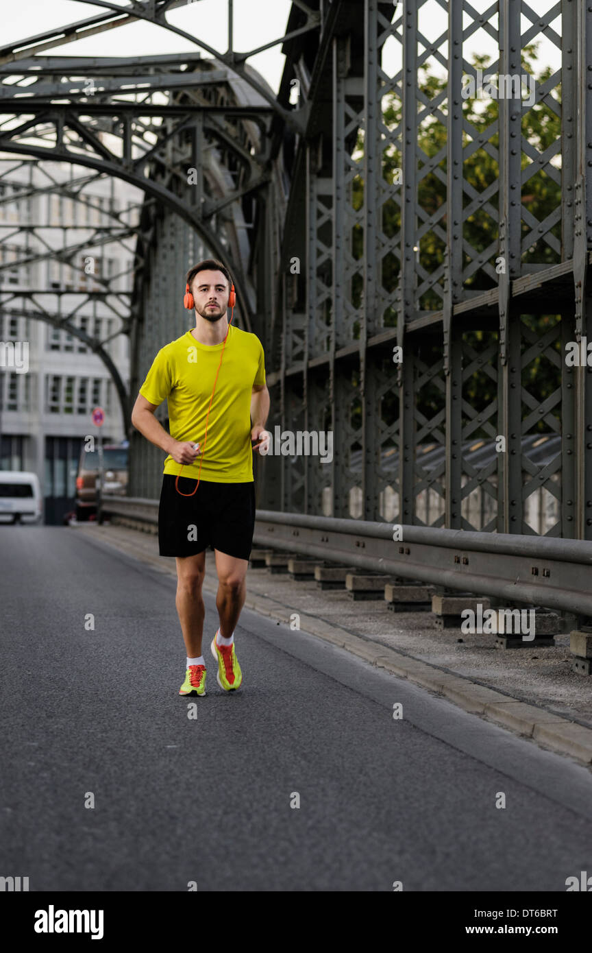 Young man running on bridge hi-res stock photography and images - Alamy