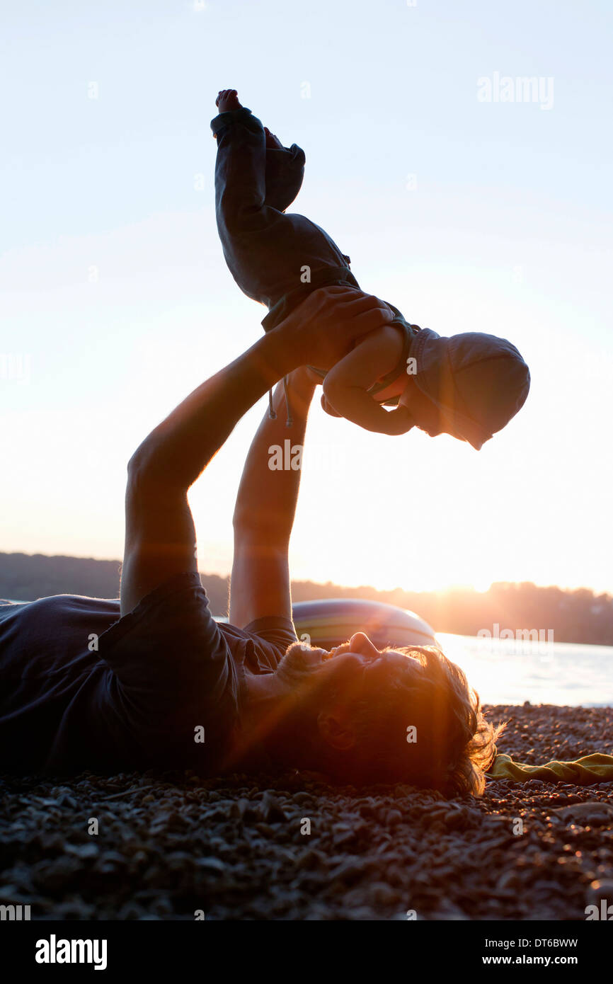 Father lifting baby daughter Stock Photo - Alamy