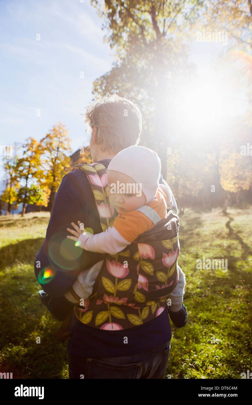 Father carrying baby daughter in carrier Stock Photo - Alamy